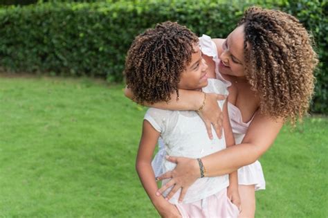 Premium Photo Happy Mother And Daughter Smiling And Hugging In The