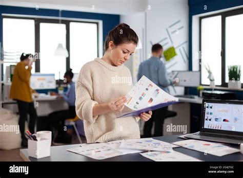 Businesswoman Working At Her Desk In The Office Checking And Analysing