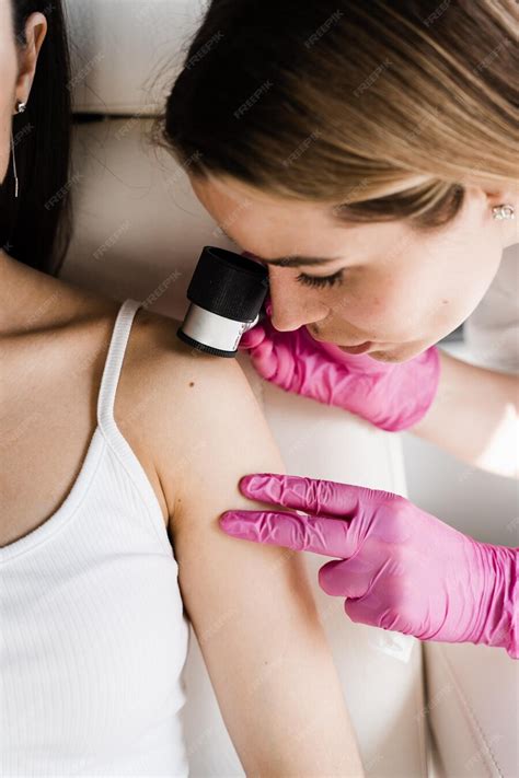 Premium Photo Dermatologist Examines Moles And Birthmarks Of Girl