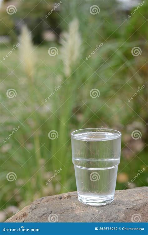 Full Glass Of Water On Stone Outdoors Space For Text Stock Image