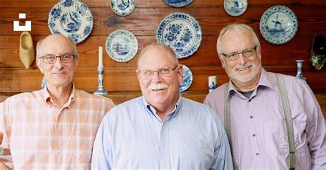 파란색과 흰색 꽃무늬 드레스 셔츠를 입은 여자 옆에 서 있는 흰색 드레스 셔츠를 입은 남자 사진 Unsplash의 무료 건물 이미지