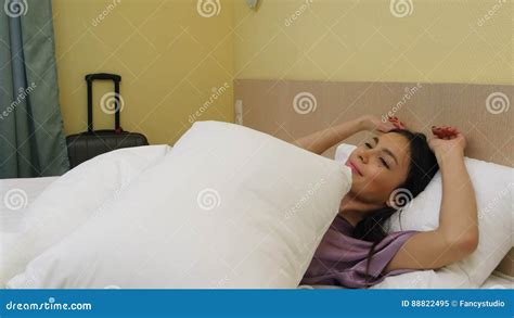 Young Beautifull Brunette Girl Wakes Up Yawns And Stretches The Body