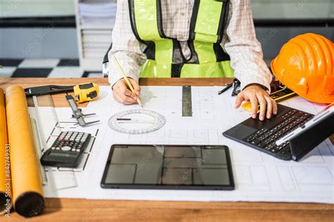 Female Architect Engineer Is Drafting Blueprints Using Cad Software Focusing On Sustainable