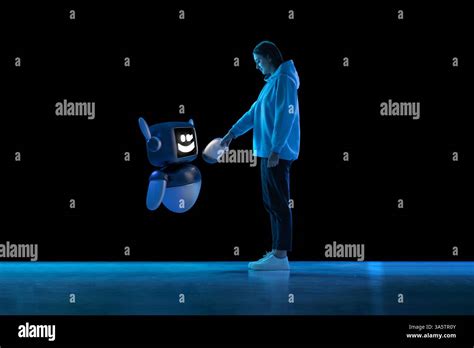 Composite Image Of Young Woman Interacting With 3d Model Of Robot Shaking Hands Visualizing