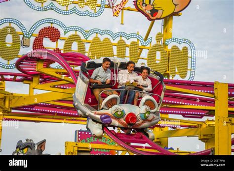 Three Teenagers On Highest Point Scared In Roller Coaster Car Ride On Annual Fair Funfair