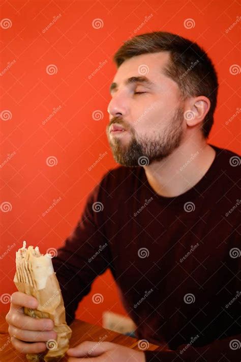 A Man With A Beard Eats Shawarma A Quick Tasty And Healthy Snack At A