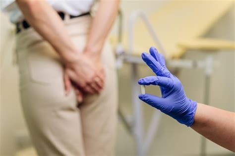 Premium Photo Woman At A Proctologists Appointment The Doctor Holds