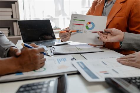 Premium Photo Calculate The Numbers According To The Report Sent To The Meeting They Are