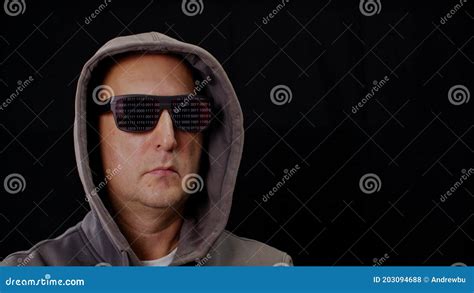 Computer Hacker In Hoodie And Black Sunglasses Reflecting Binary Code On Black Background Male
