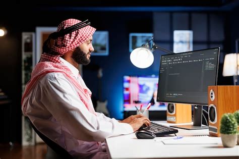 Premium Photo Image Shows An Arab Software Developer Working At The Pc Monitor Seated At A
