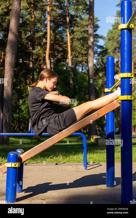 A Teenage Girl Doing Abdominal Crunches A Girl Performs Exercises For