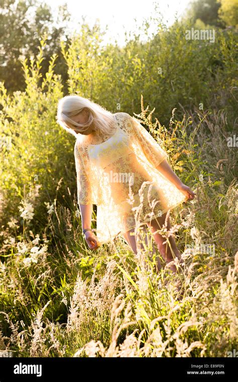 A Young Teenage Blonde Girl Woman Outdoors Wearing A See Through Yellow