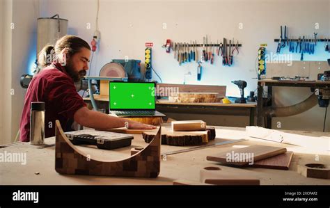 Upbeat Men Using Cad Software On Isolated Screen Laptop Debating Wood