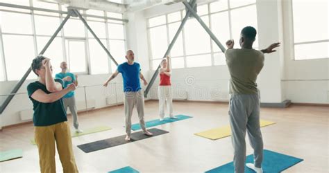 Group Of Senior Fellows Stretching Arms On Yoga Class Stock Footage
