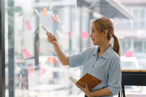 Businesswoman Uses Sticky Notes To Share Ideas Showcasing The Concept
