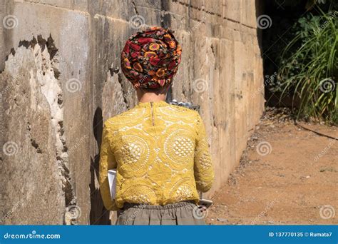 Undefined Woman Wandering Along Typical Narrow Medieval Street Of Mdina