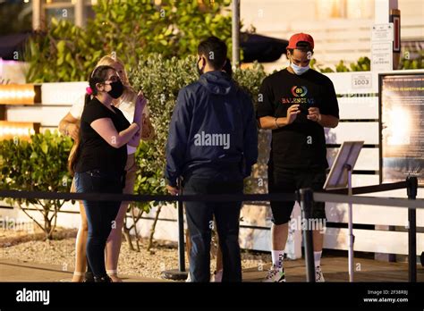 Club Bouncer Checking ID At The Entrance To The Wharf Miami Stock Photo Alamy