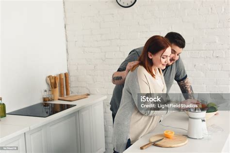 동안 그녀는 주방에서 주스를 만드는 남자 친구 포옹 여자 친구과 체중 과체중에 대한 스톡 사진 및 기타 이미지 과체중 커플