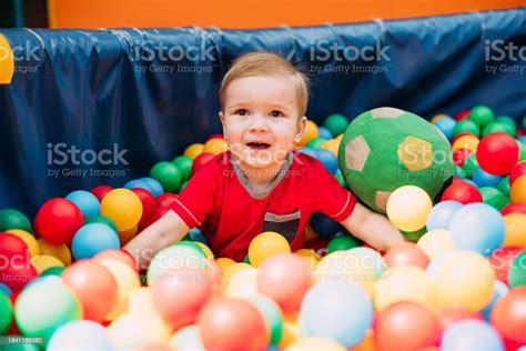행복한 웃음 소년 12 세 아이 놀이 공원과 실내 놀이 센터에서 생일 파티에 볼 구덩이에서 재미를 놀이터 공 수영장에서 화려한 공을 가지고 노는 아이 어린 아이를위한 활동