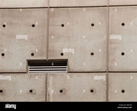 Raw Concrete Wall Background With Formwork Lines And Tie Hole Plugs