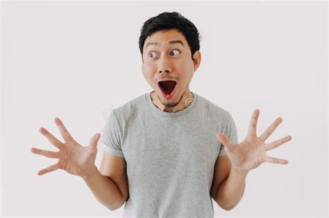 Shocked Asian Man With Open Mouth And Hands Spread In Disbelief Stock