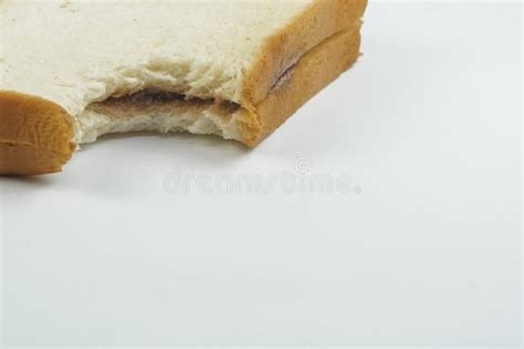 Two Layers Of White Bread With Bite Marks On A White Background Stock