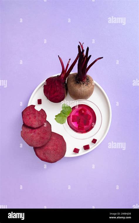 Top View Of Round Shaped Dish Containing Beetroot Slices And A Cocktail