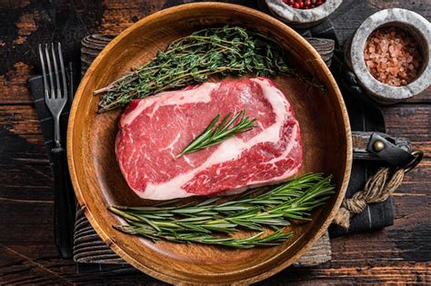 Premium Photo Ribeye Raw Steak Rib Eye Beef Marbled Meat In Wooden