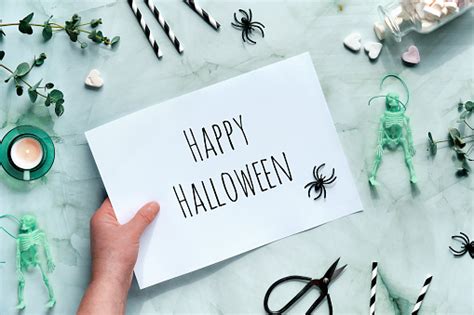 민트 녹색 배경에 손에 텍스트 해피 할로윈 페이지 손에 해골 유칼립투스 차 빛 가위 와 휴일 장식플랫 누워 11월에 대한 스톡 사진 및 기타 이미지 Istock