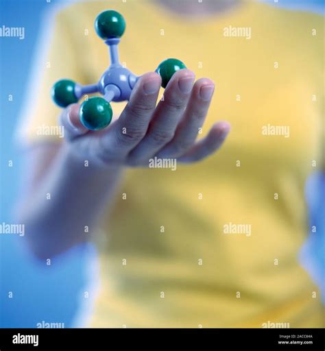 Silicon Tetrafluoride Molecule Chemist Holding A Molecular Ball And Stick Model Of The