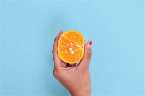 Premium Photo Sex Education With Orange Isolated On Blue Background