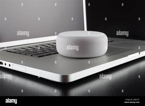 White Digital Voice Assistant With Computer On A Black Background Stock
