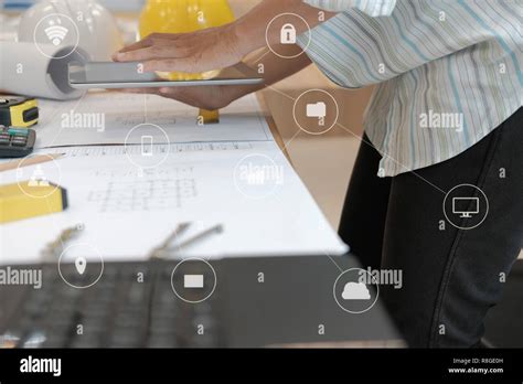 Architect Using Tablet Engineer Working On House Blueprint Of Real Estate Project At Workplace