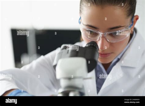 Female Chemist Investigate Sample Under Microscope Equipment In Lab Stock Photo Alamy