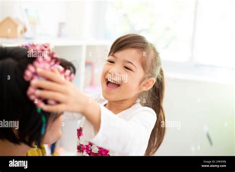 Girl Playing With Mother Stock Photo Alamy