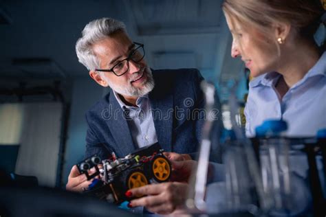 Two Robotics Engineers Working On New Project Standing In Laboratory Concept Of Modern