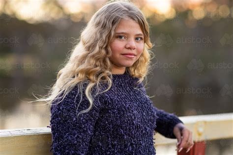 Image Of Young Aboriginal Girl With Blonde Hair Looking At Camera