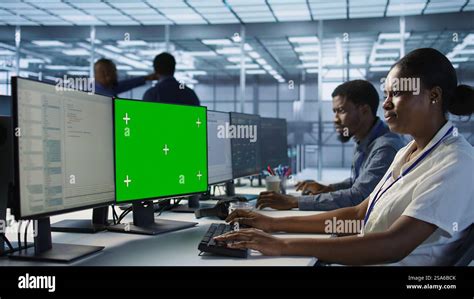 Technician Using Isolated Screen Computer Working In Server Farm To Optimize It For Data