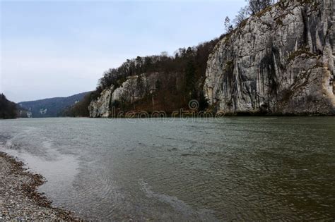 Rocks With Trees Above A Picturesque River A Wide Stream Flows Into The Distance Stock Image