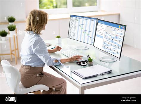 Employee Using Schedule Calendar On Computer Screen Stock Photo Alamy
