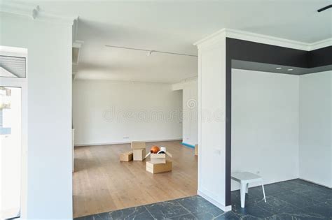 Townhouse With Different Objects In Cardboard Boxes On Floor During