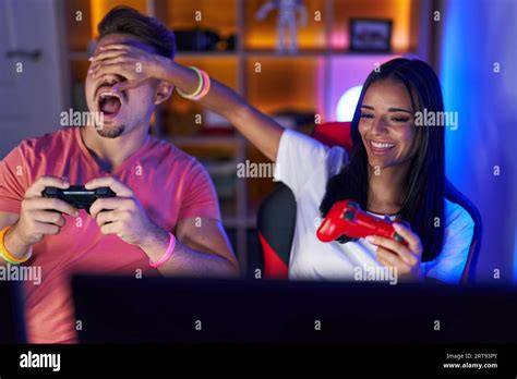Man And Woman Streamers Playing Video Game Using Computer And Joystick Cheating At Gaming Room