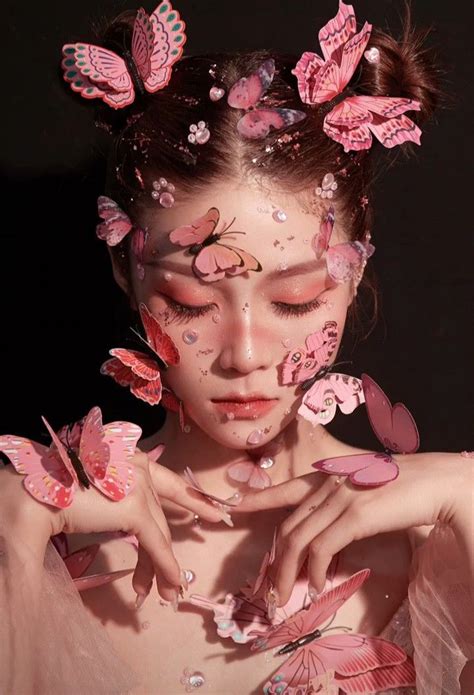 A Woman With Pink Butterflies On Her Face And Hands Over Her Chest In A Woman With Pink Butterflies On Her Face And Hands Over Her Chest In