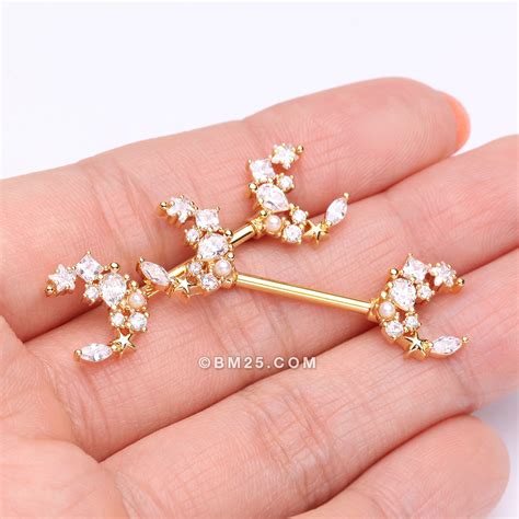 a pair of golden celestial sparkle crescent moon array nipple barbell