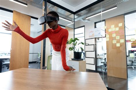 Woman Using Vr Headset In Modern Office Interacting With Virtual Environment Stock Image
