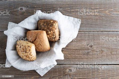 베이지 색 린넨 냅킨에 해바라기 씨 치아 오트밀을 곁들인 신선한 빵 3개가 있습니다 나무 배경입니다 공간을 절약합니다 신선한 빵집 갈색에 대한 스톡 사진 및 기타 이미지