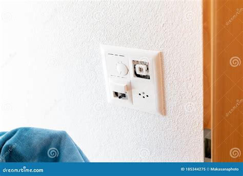 Close Up Of A Professional Cleaner Cleaning A Modern Light Switch And