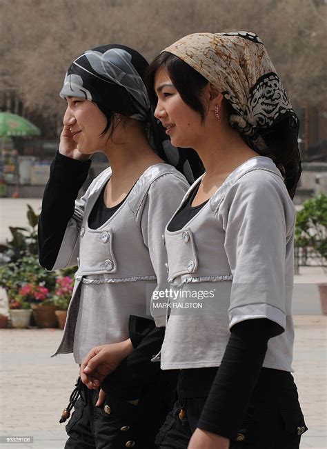 Two Young Chinese Muslim Uighur Women Walk In The Town Of Kashgar