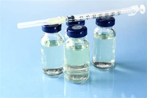 Premium Photo Vaccine In Vial With Syringe