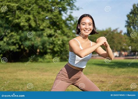 Wellbeing And Sport Complex Young Asian Woman Stretching Doing Squats